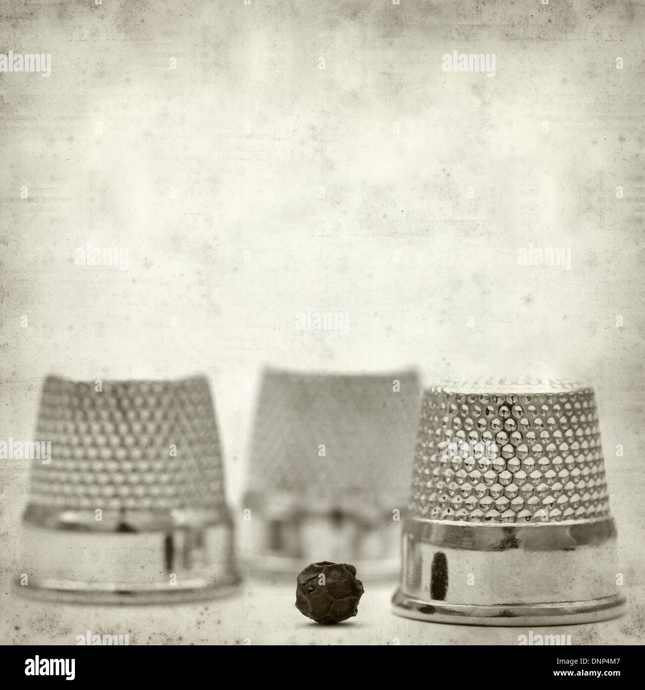 textured old paper background with thimbles Stock Photo - Alamy