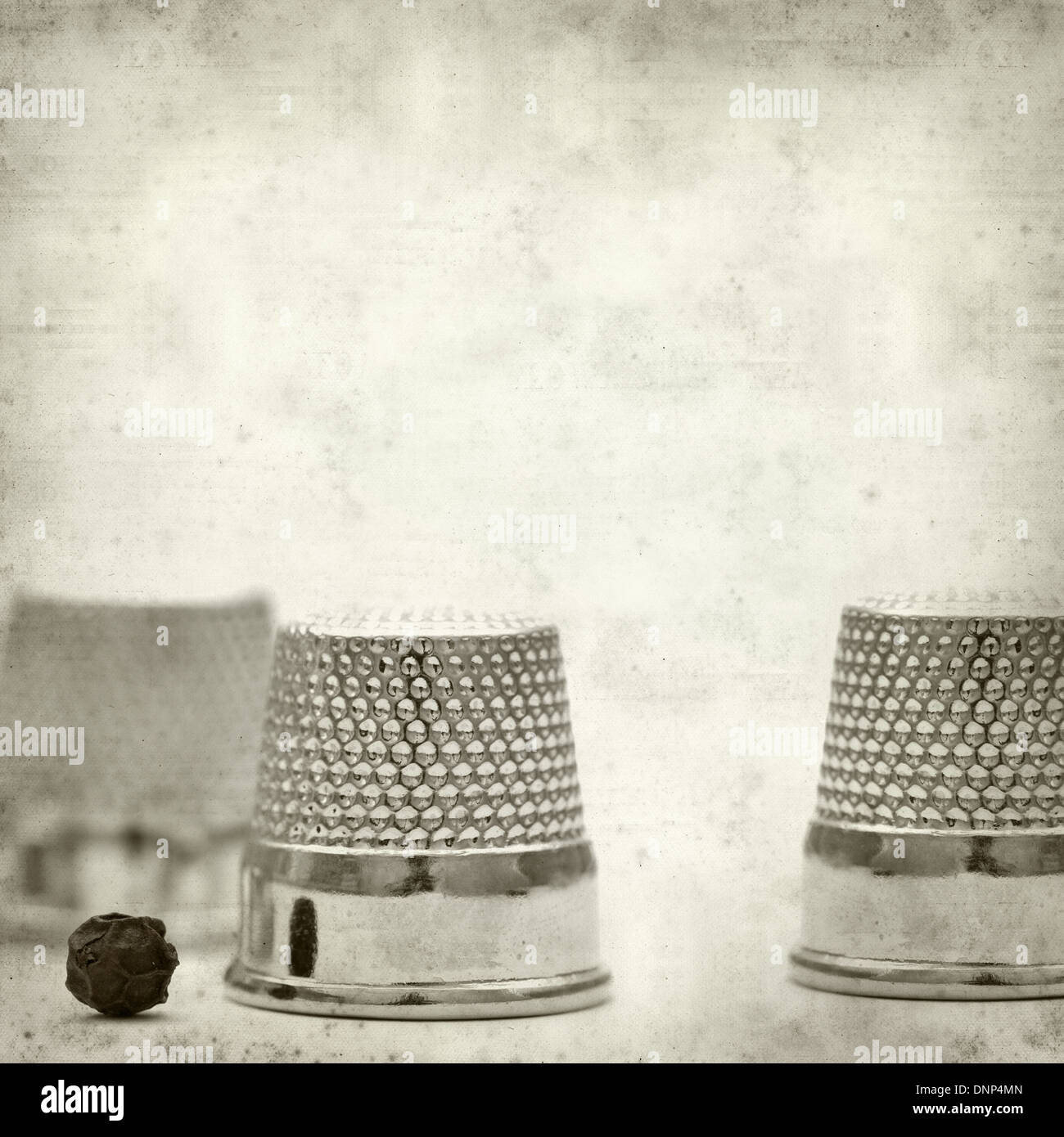 textured old paper background with thimbles Stock Photo - Alamy