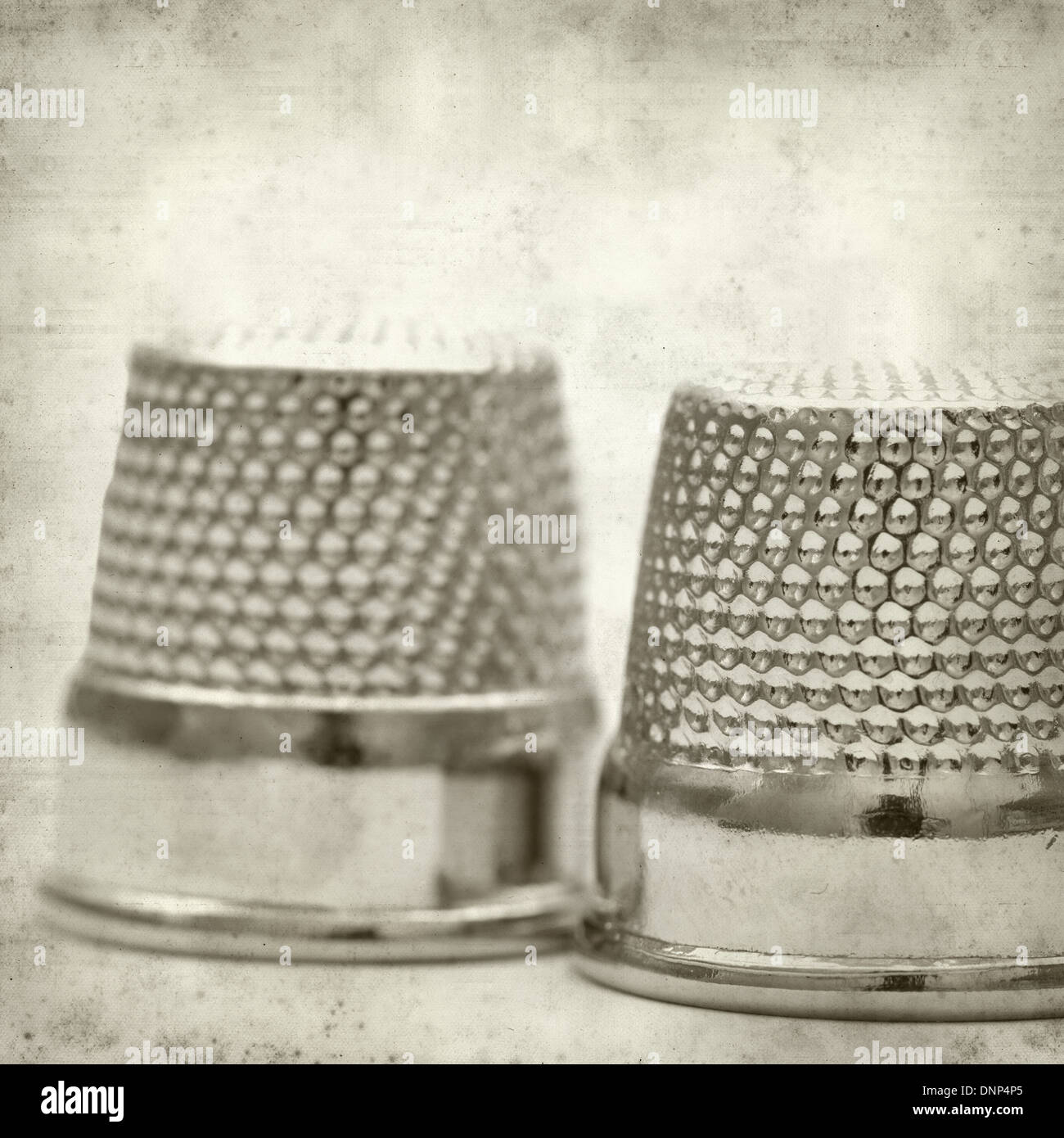 textured old paper background with thimbles Stock Photo - Alamy