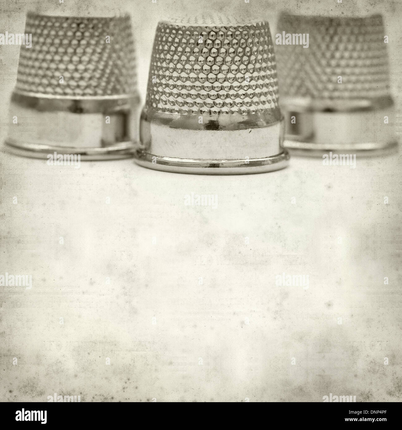 textured old paper background with thimbles Stock Photo - Alamy