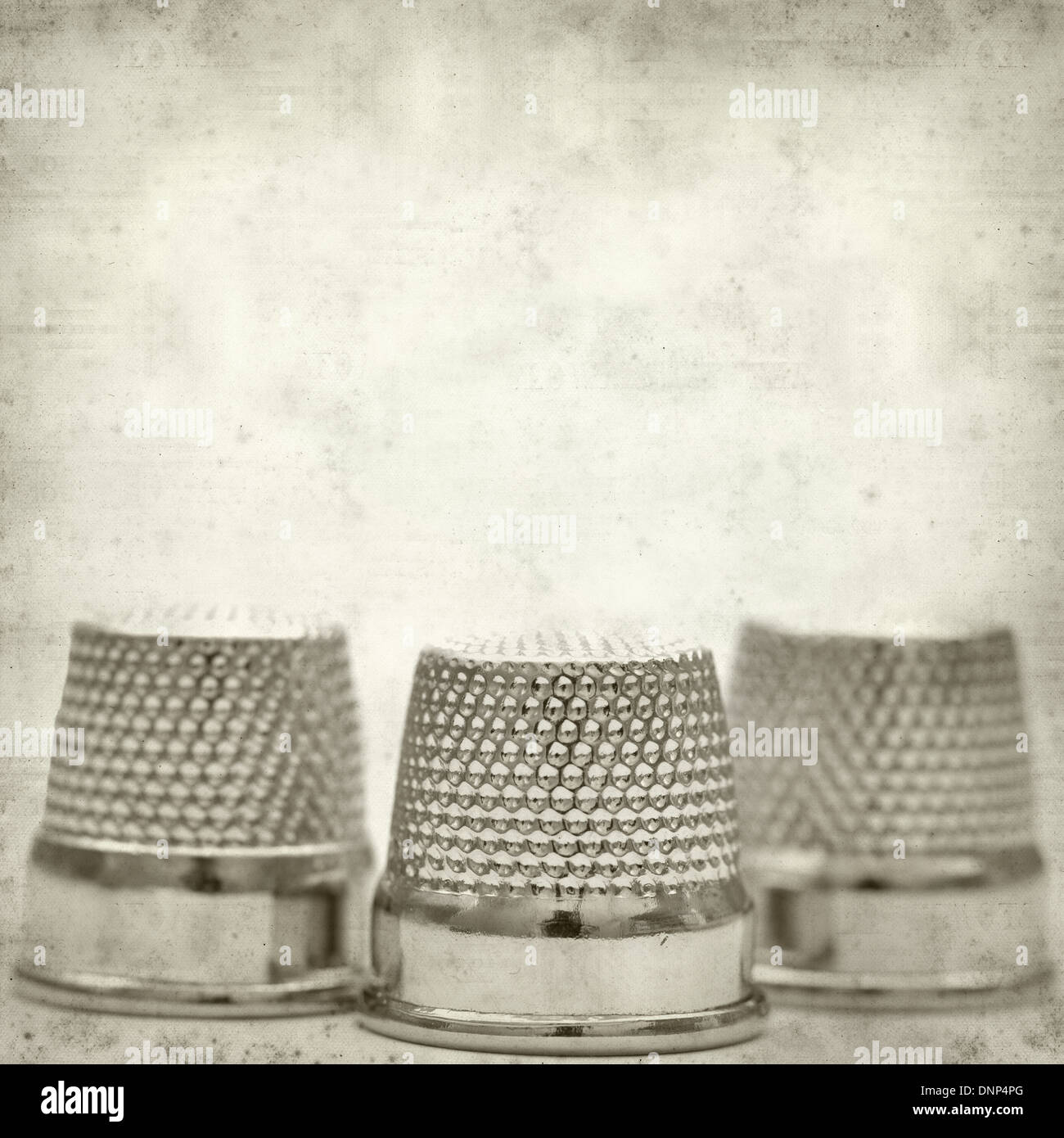 textured old paper background with thimbles Stock Photo - Alamy