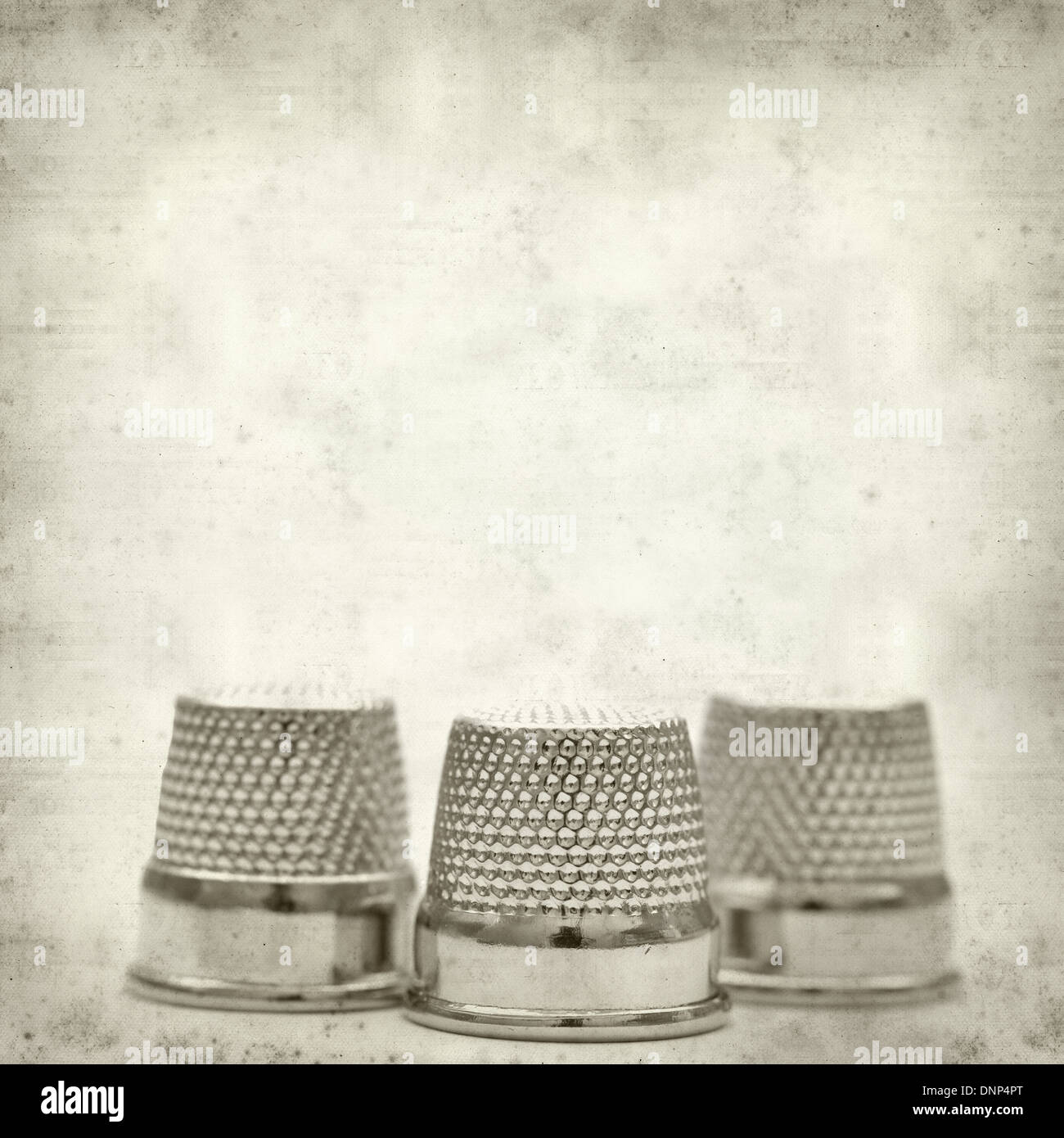 textured old paper background with thimbles Stock Photo - Alamy