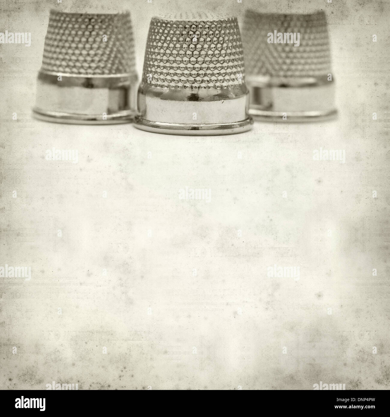 textured old paper background with thimbles Stock Photo - Alamy