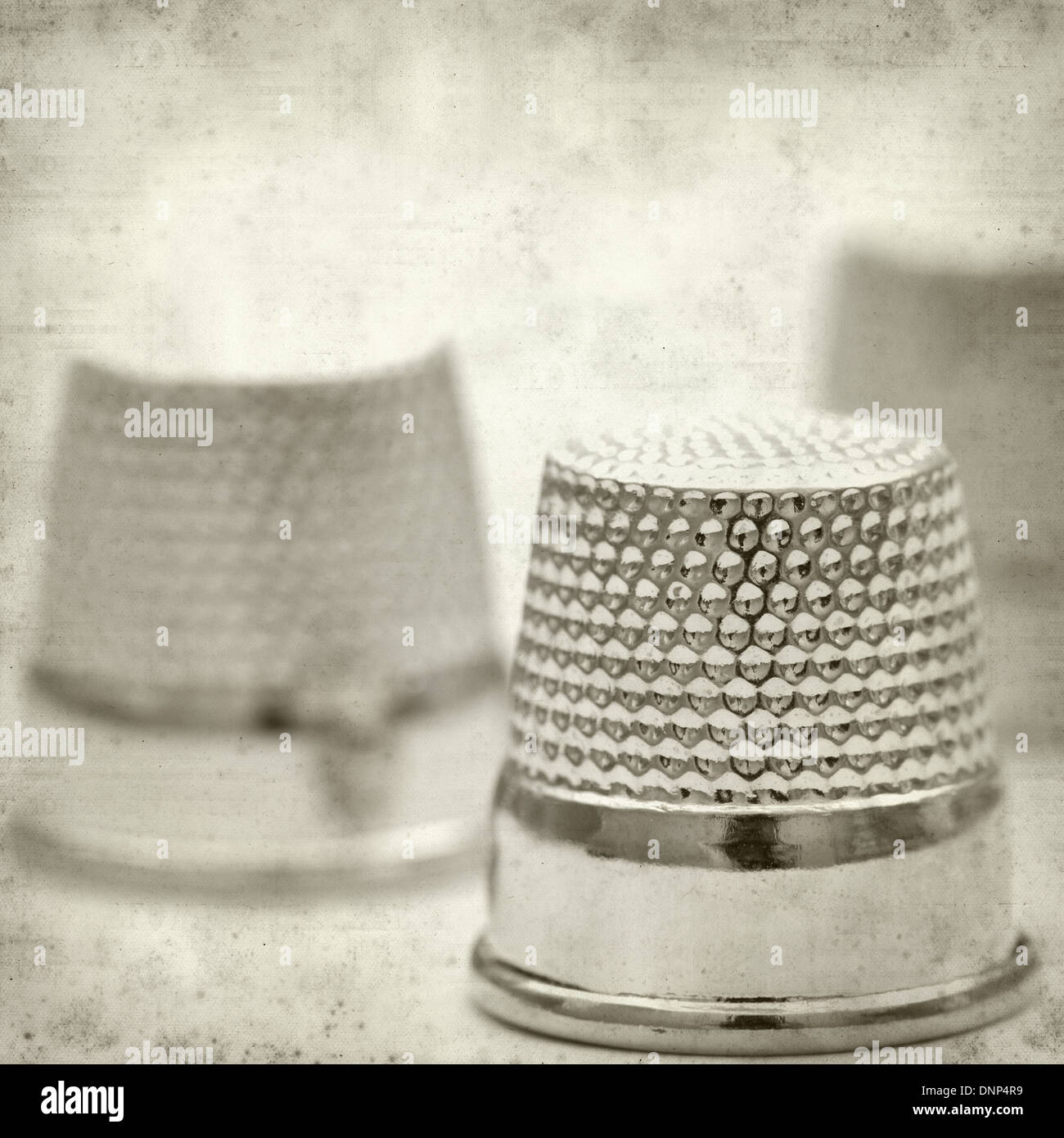 textured old paper background with thimbles Stock Photo - Alamy