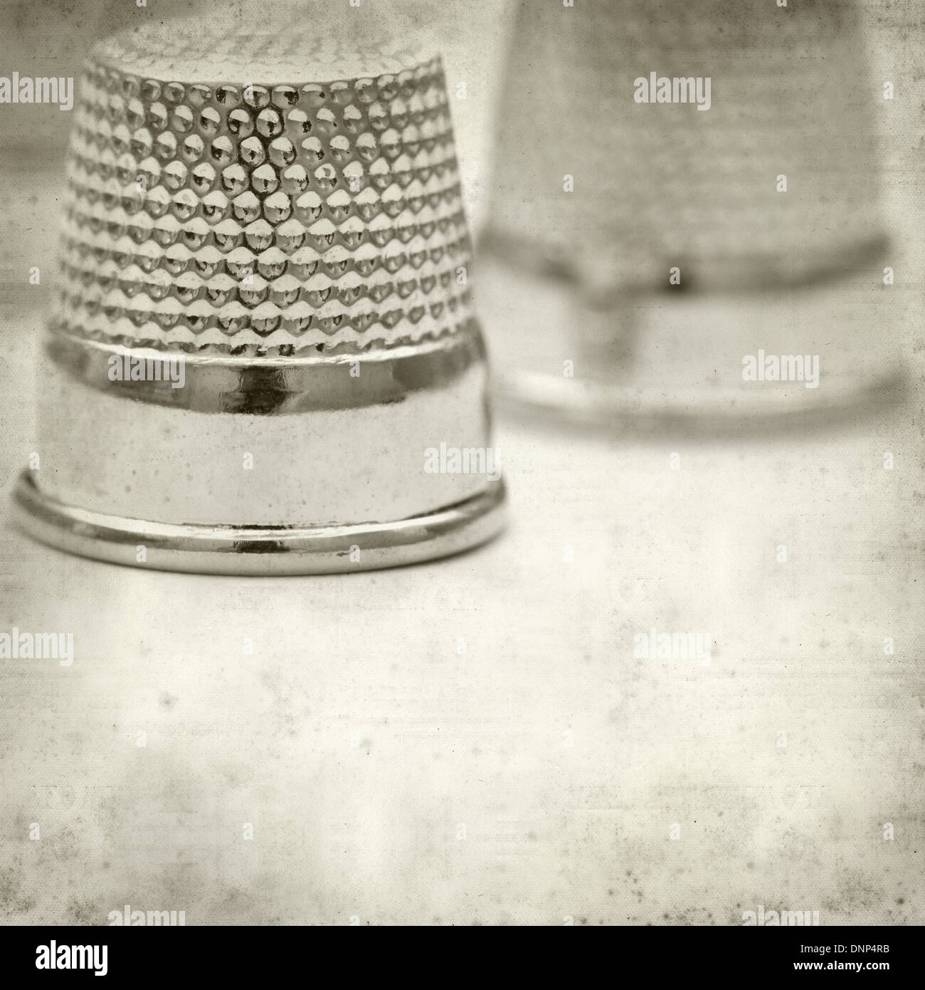 textured old paper background with thimbles Stock Photo - Alamy