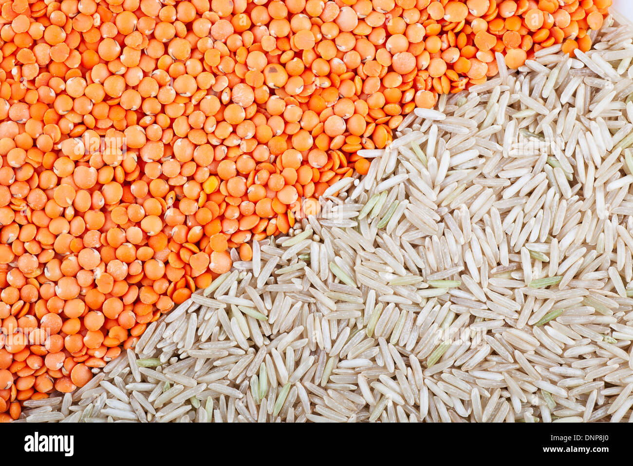 Red lentils and brown rice background split diagonally Stock Photo - Alamy
