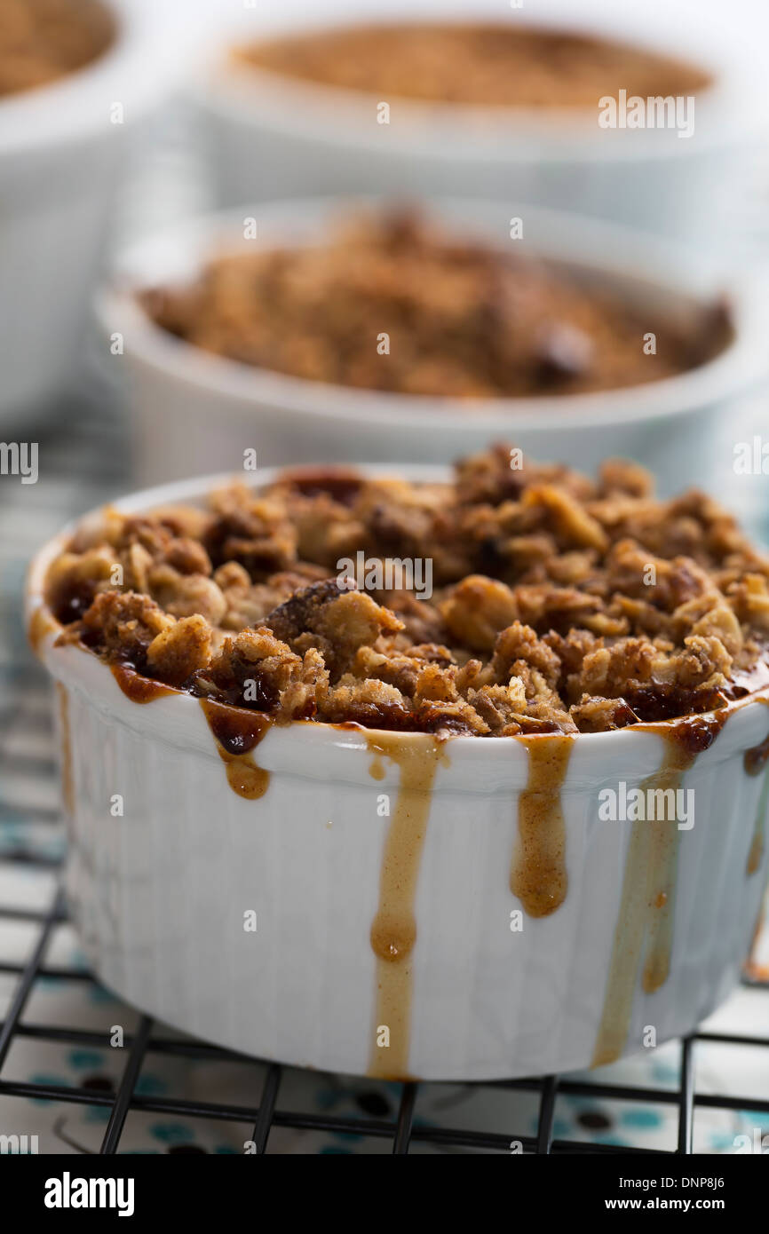 Personal sized apple crumble with filling dripping down the sides Stock ...