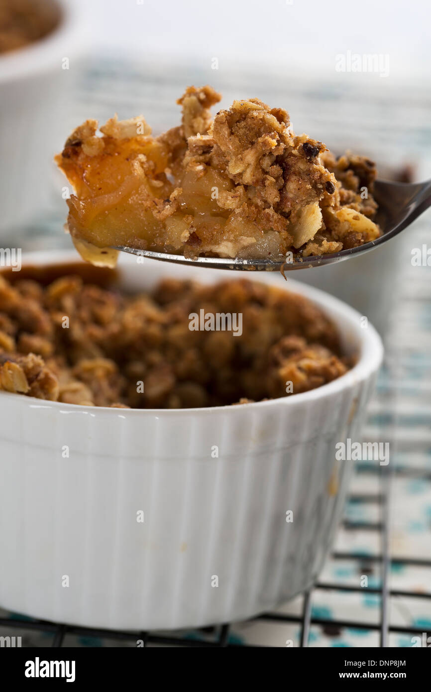 Spoon full of fresh apple crumble from single serving Stock Photo - Alamy