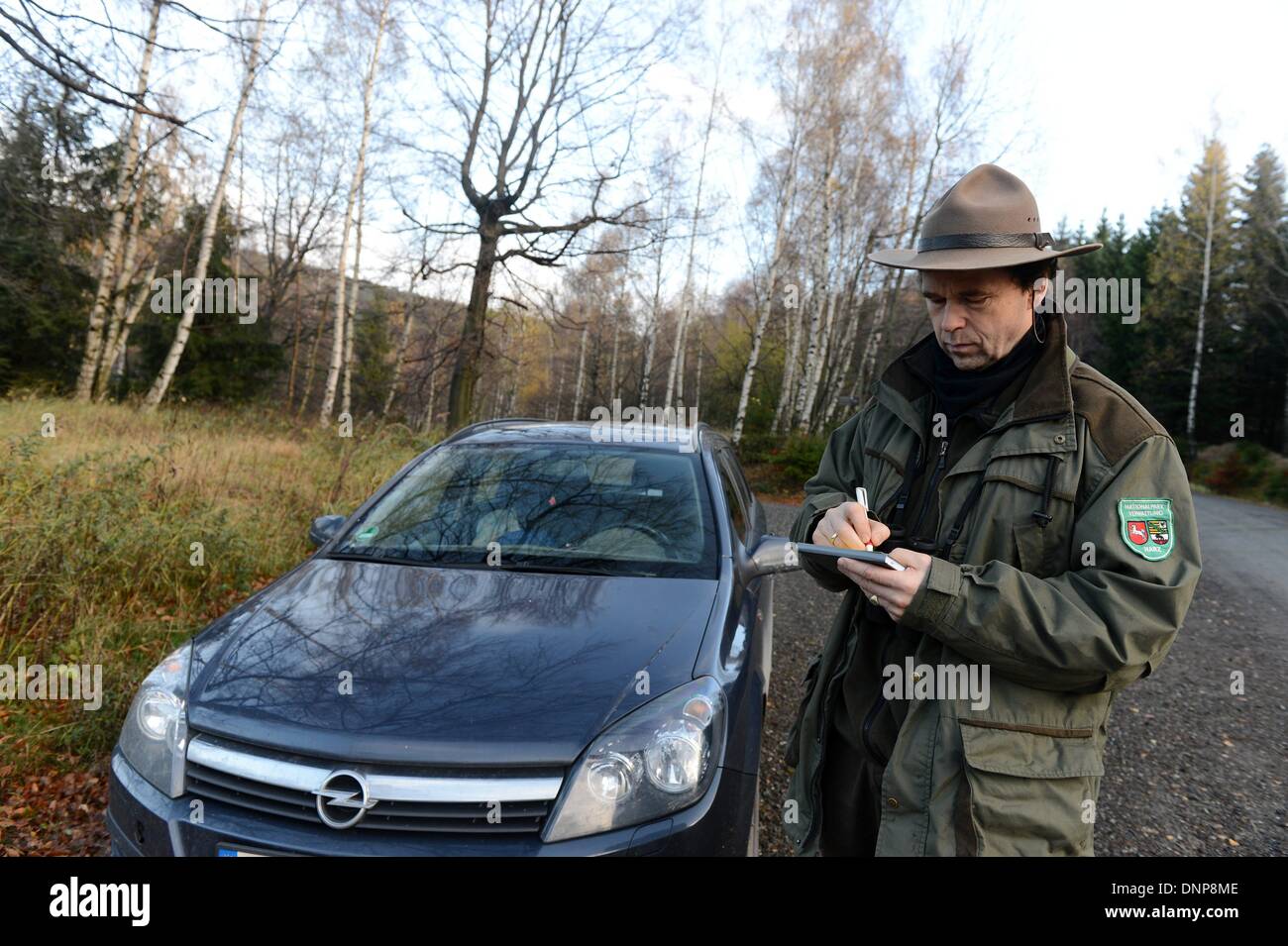 National park ranger Wolfgang Friedersdorf is writing a ticket to a car ...