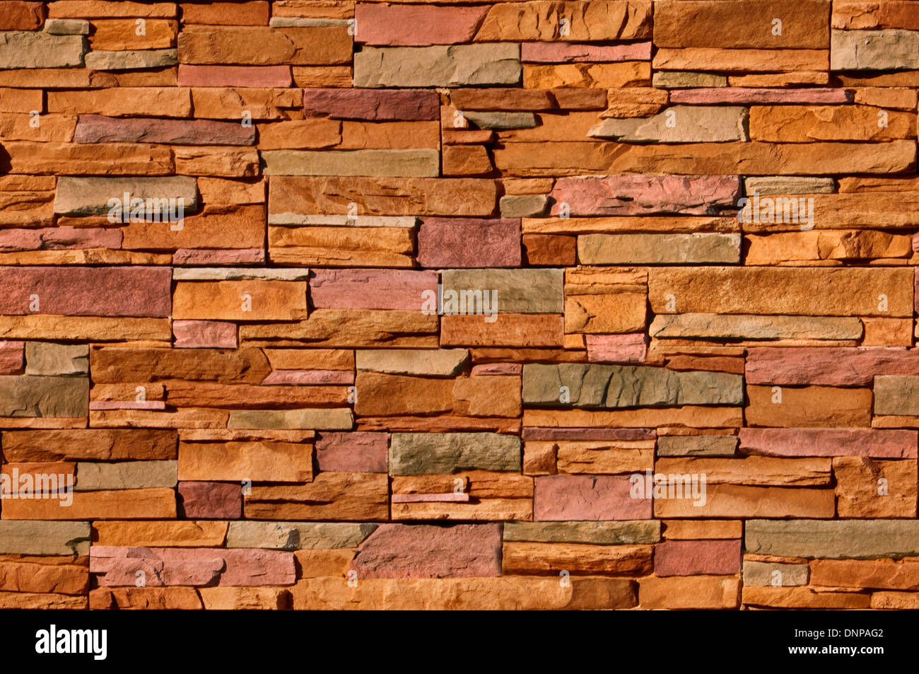 Irregular sized multi-colored bricks with an organic feel. Image is ...