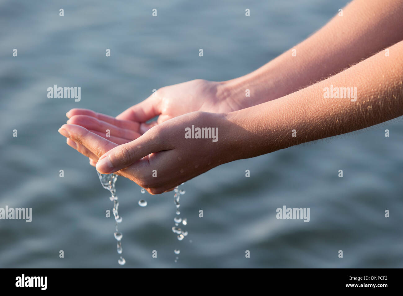 Woman's hands with waterdrops Stock Photo - Alamy
