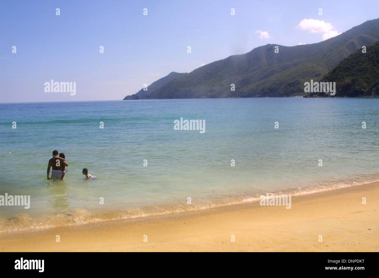 A family bathes in Playa Grande beach in Puerto Colombia, Choroni ...