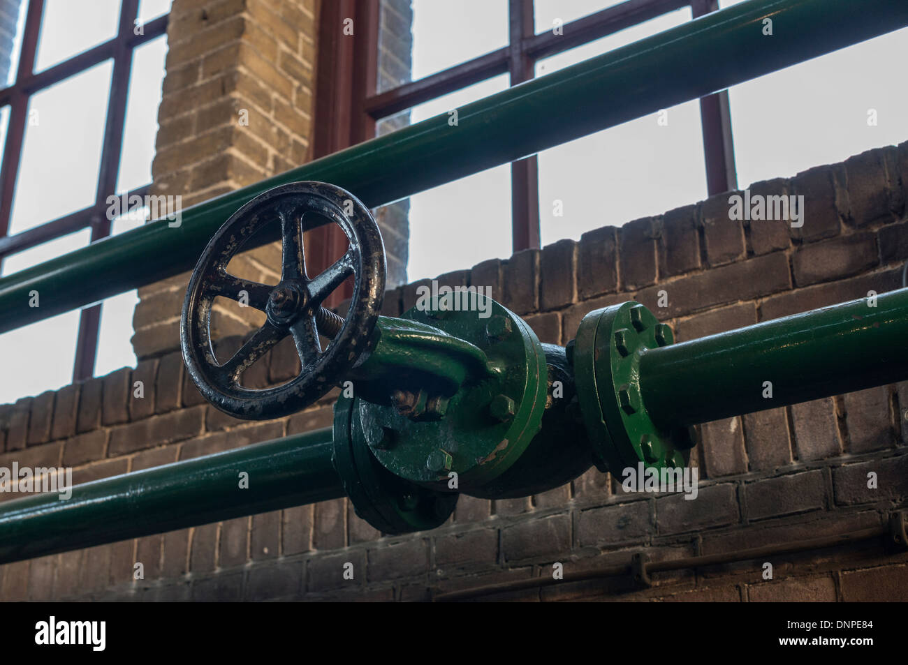 green manual valve in green metal tube in industrial building Stock ...