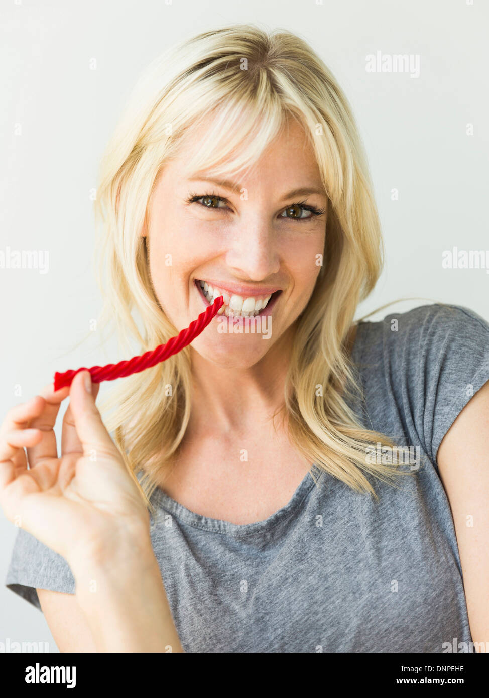 Woman eating candy Stock Photo - Alamy