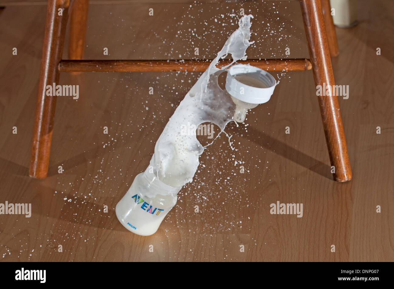 milk bottle splashing on the floor Stock Photo - Alamy