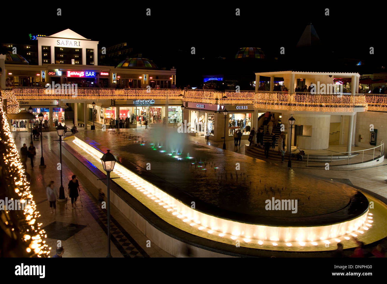 shopping centre and fountain lit up at night, Playa de Las Americas ...