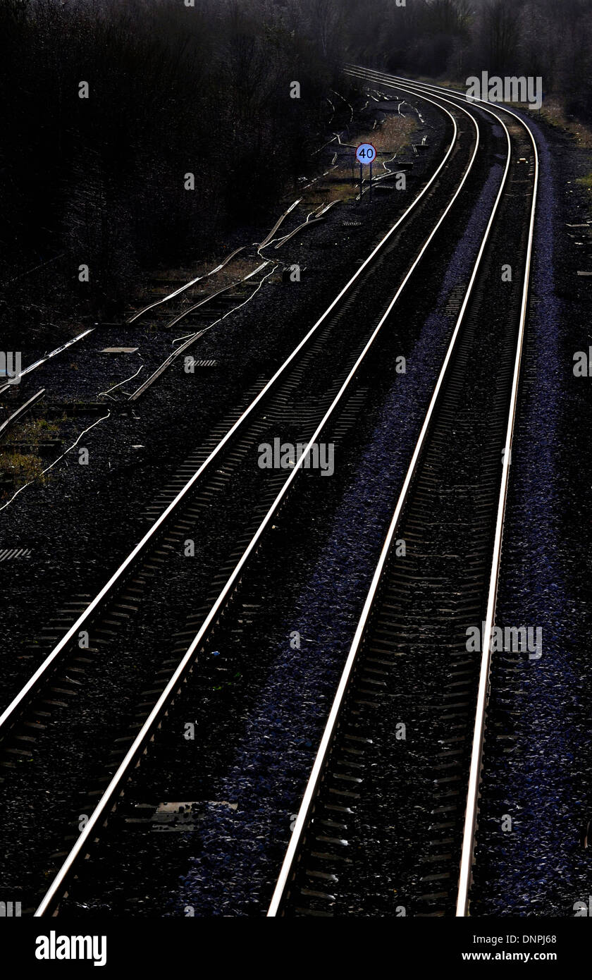 Two steel rail tracks with no train stretching out into the short ...