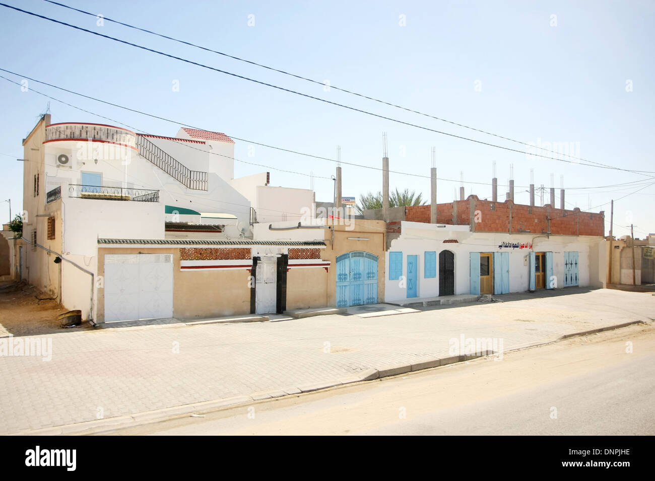 Typical Tunisian half finished house with blue doors and windows and ...