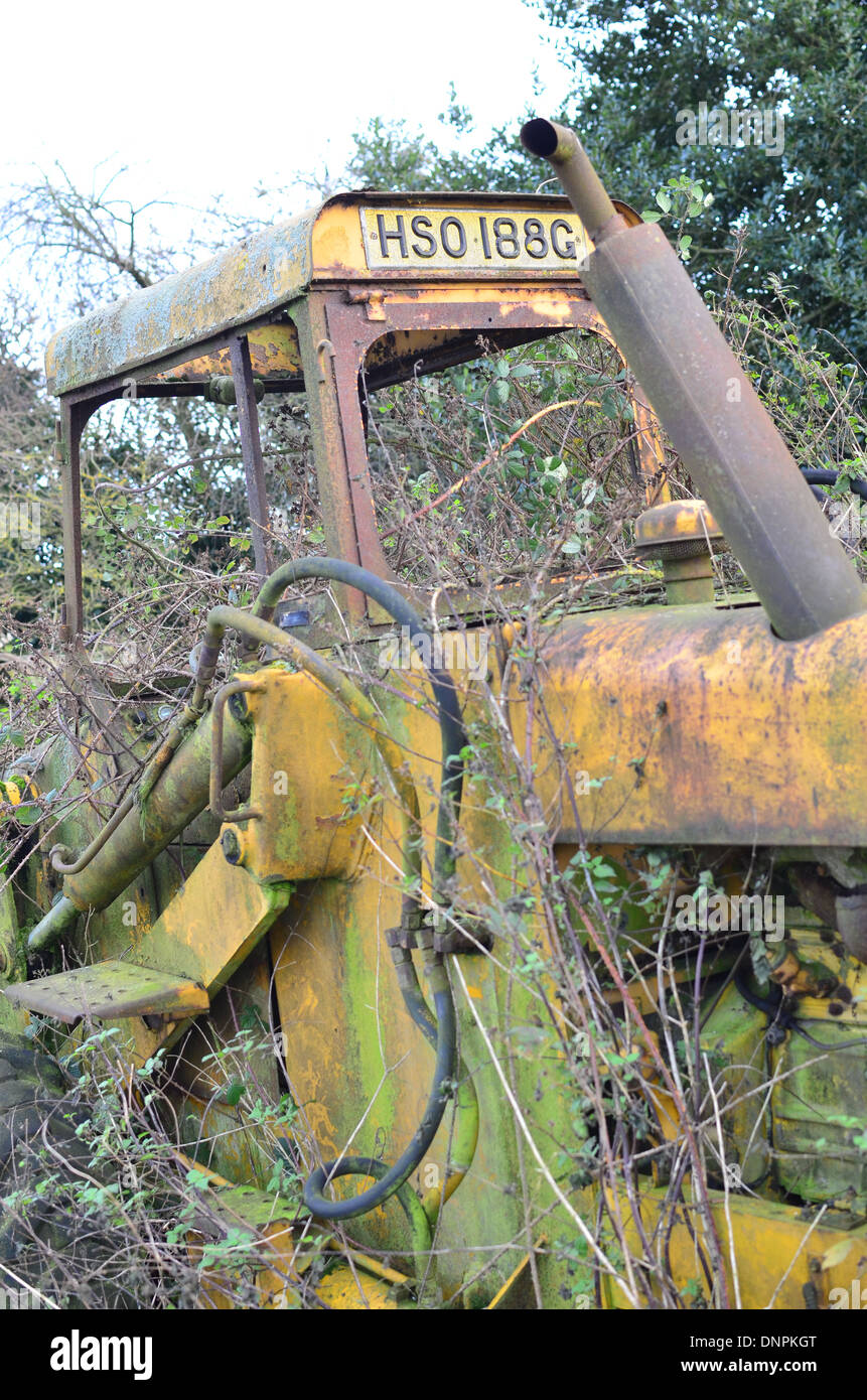 old digger cover in trees Stock Photo - Alamy