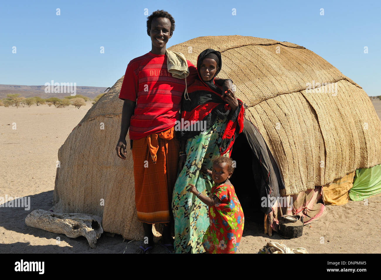 An Afar family posing in front of their hut in the south desert of ...