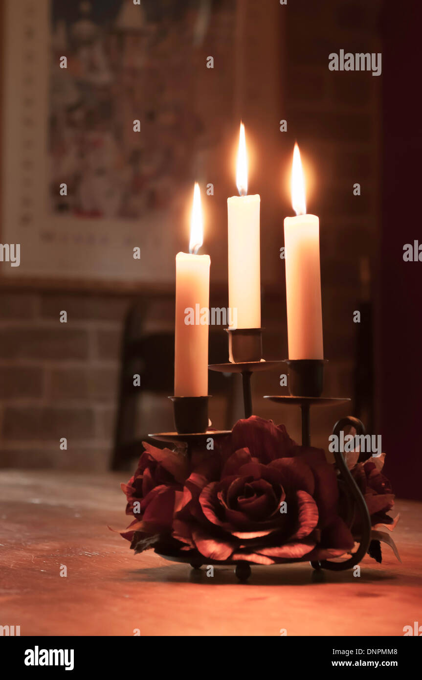 glowing candles with beautiful candlelight on a table Stock Photo - Alamy