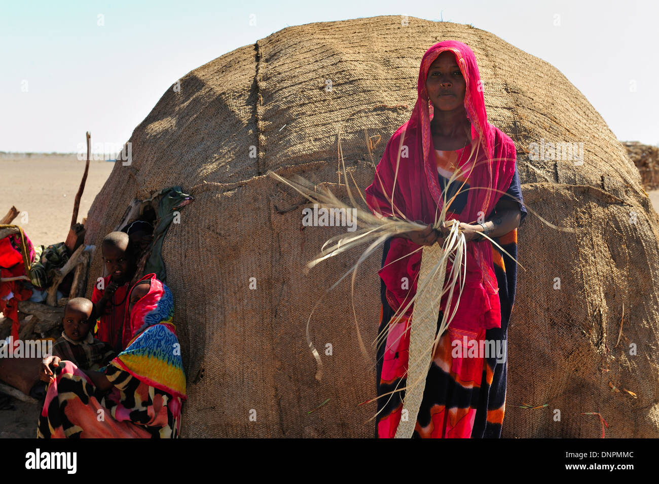 An Afar family posing in front of their hut in the south desert of ...
