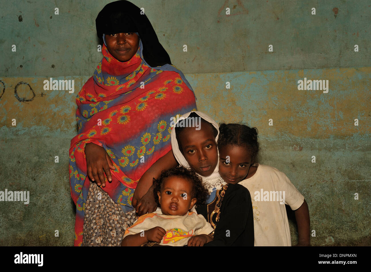 Woman posing with her three girls in Dikhil town in the south of ...