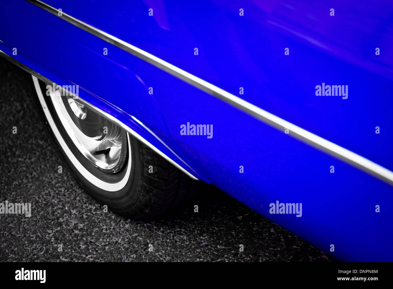 Detail of the back wheel of a vintage blue car Stock Photo - Alamy