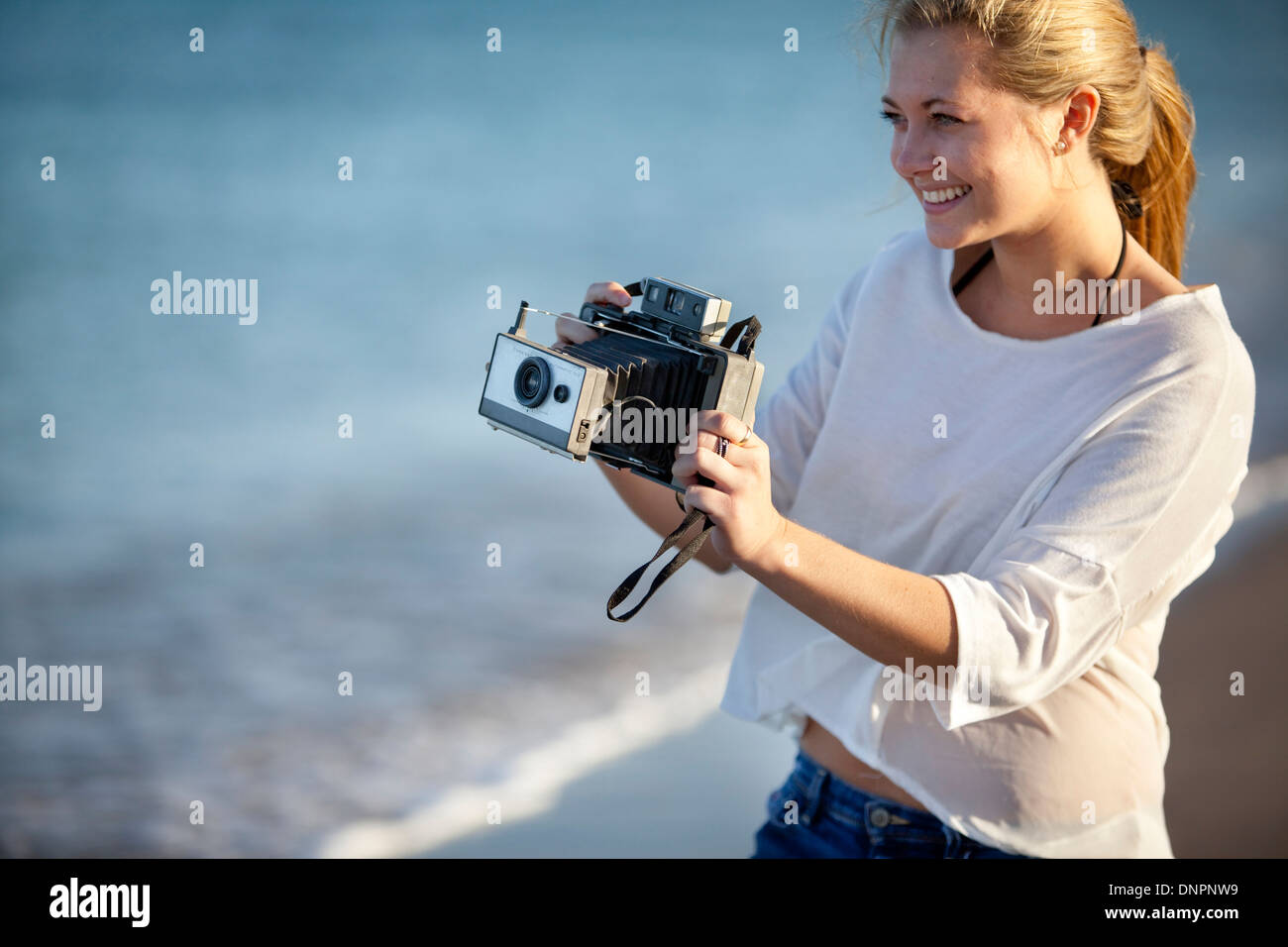 Young Woman Taking Pictures at Beach with Camera, Palm Beach Gardens ...
