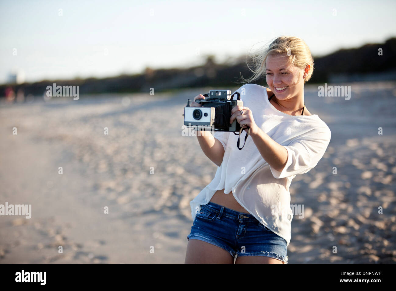 Young Woman Taking Pictures at Beach with Camera, Palm Beach Gardens ...