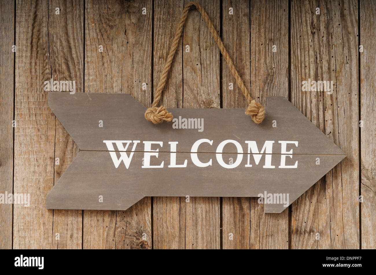 Welcome Sign shaped like Arrow Hanging on Wall Stock Photo - Alamy