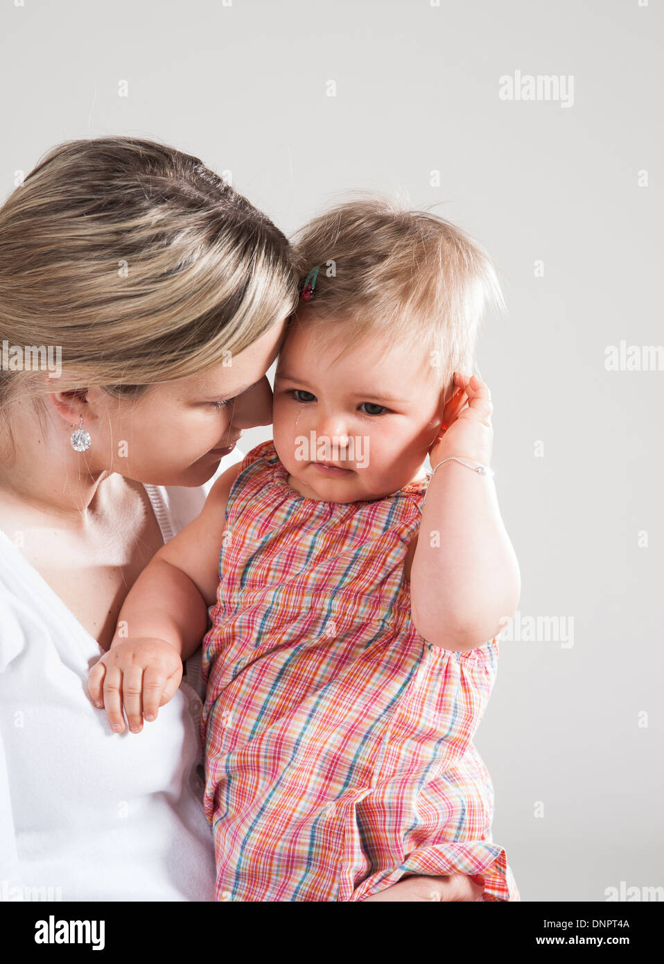 Little girl crying holding ear hi-res stock photography and images - Alamy