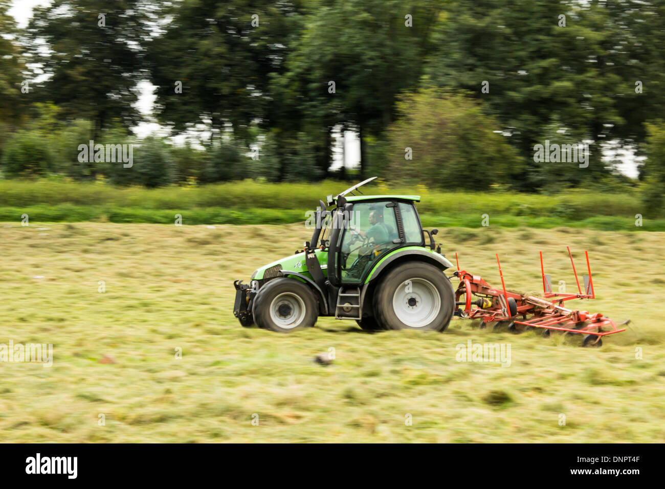 Farmer Turning Cut Hay in Late Summer Stock Photo - Alamy
