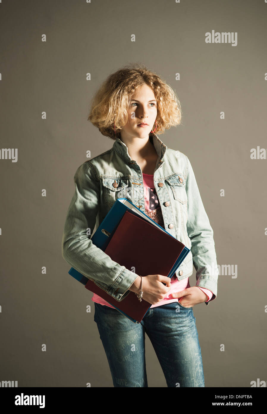 Portrait of Teenage Girl with Binders, Studio Shot Stock Photo - Alamy