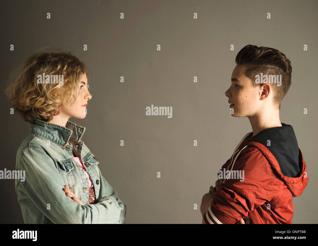 Staring at each other arms crossed hi-res stock photography and images ...