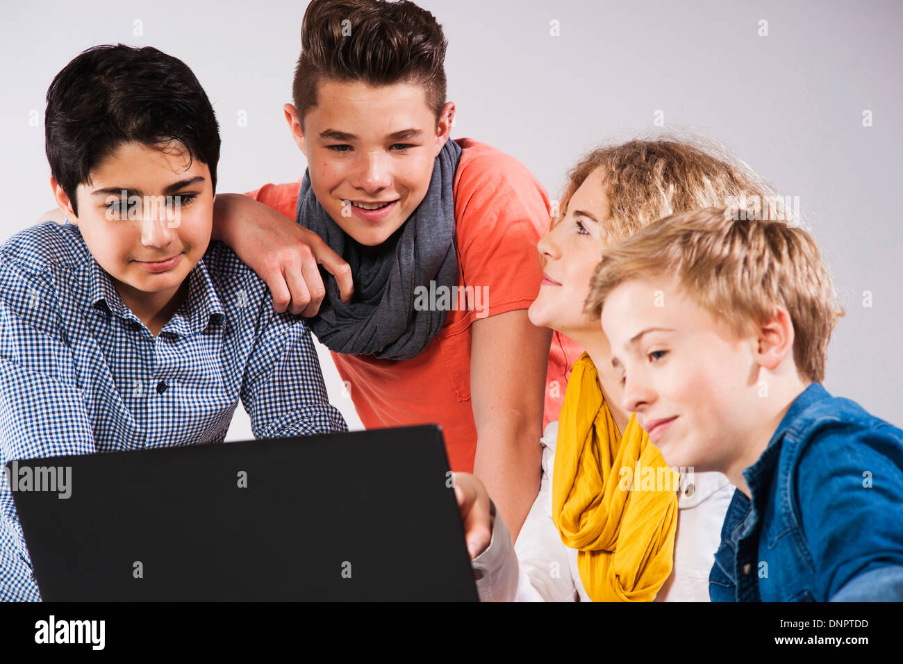 Teenagers Looking at Laptop Computer, Studio Shot Stock Photo - Alamy
