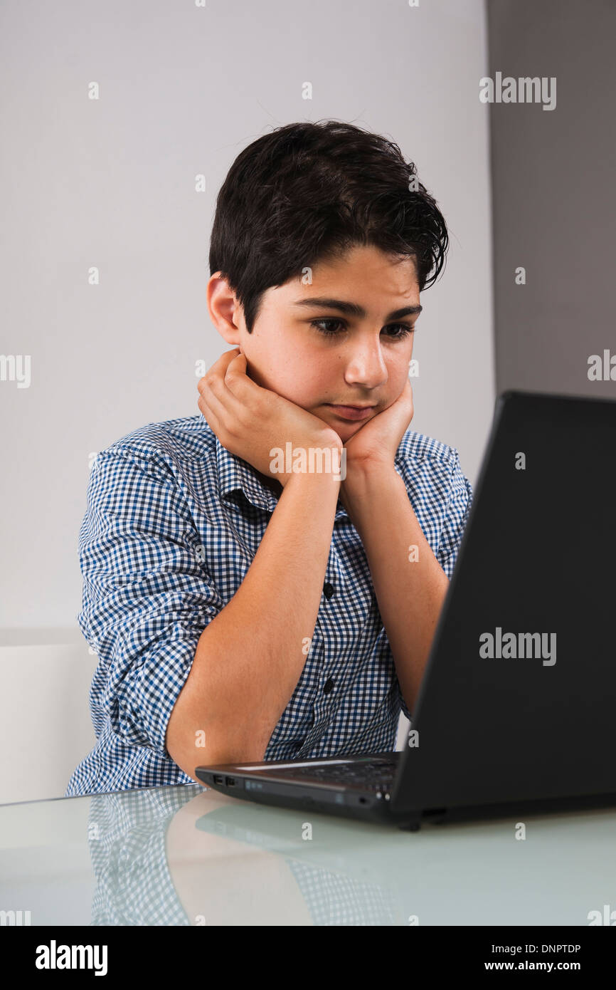 Teenage Boy using Laptop Computer, Studio Shot Stock Photo - Alamy