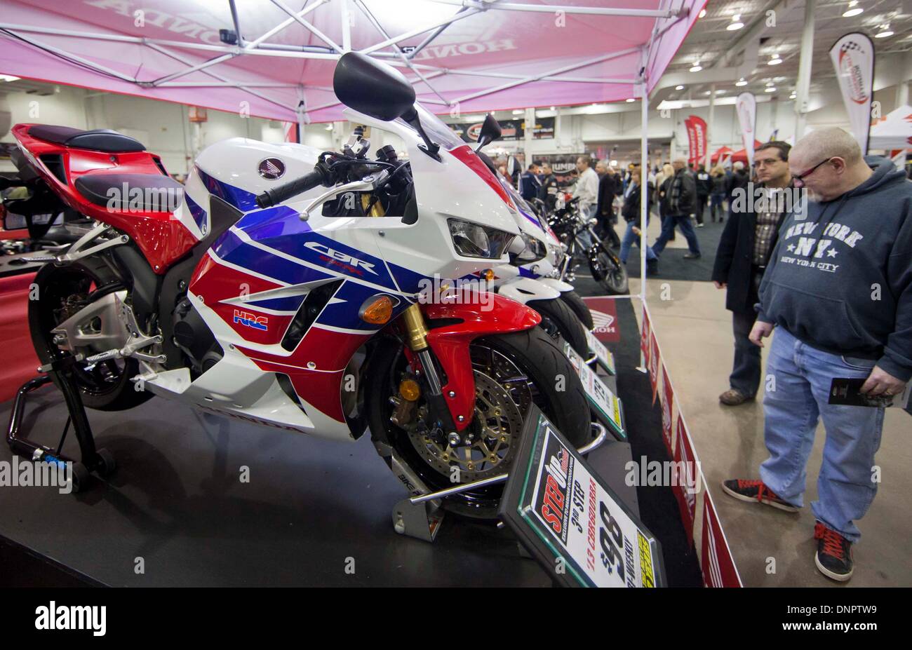 Toronto, Canada. 3rd Jan, 2014. Visitors look at motorcycles during the ...