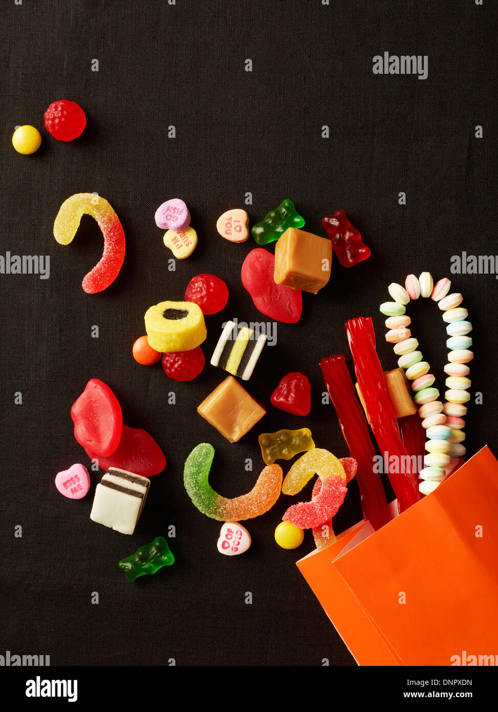 Assorted Candy Spilling out of Bag Stock Photo - Alamy