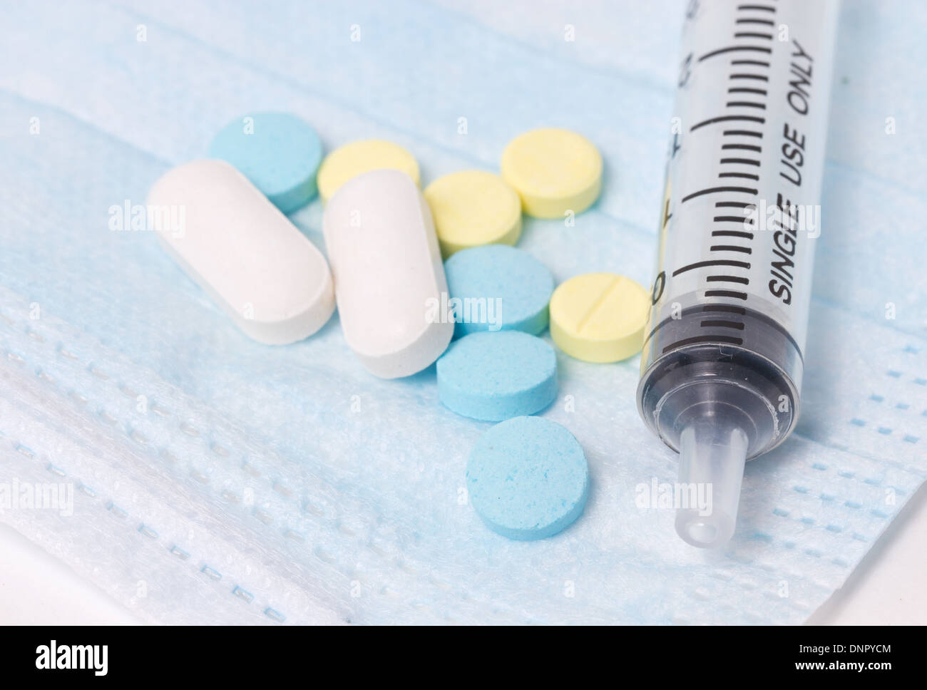 Syringe, medicine tablets and face mask Stock Photo - Alamy