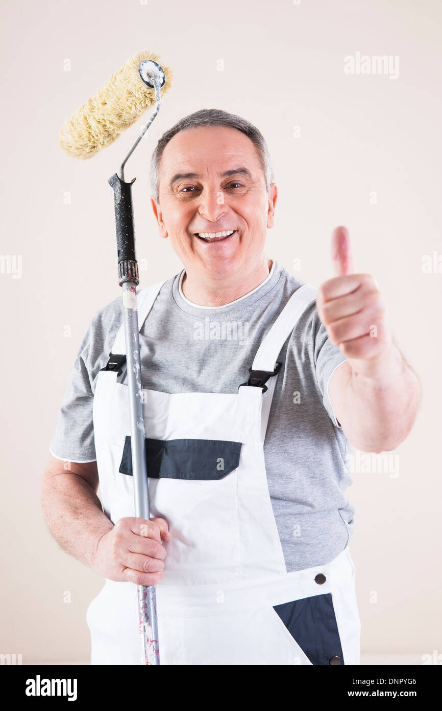 Portrait of Painter giving Thumbs Up and holding Paint Roller, Studio ...