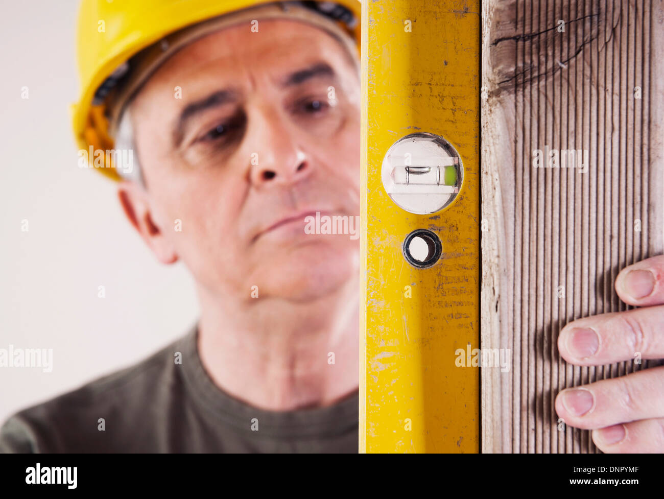 Portrait of Carpenter using Level, Studio Shot Stock Photo - Alamy