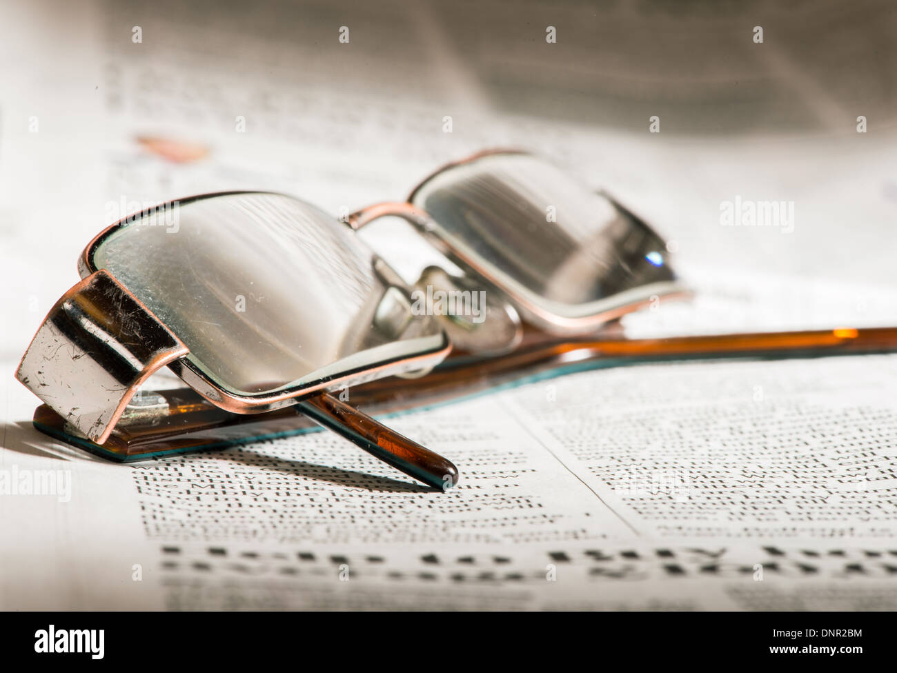 Glasses on newspaper. Natural lightings Stock Photo - Alamy