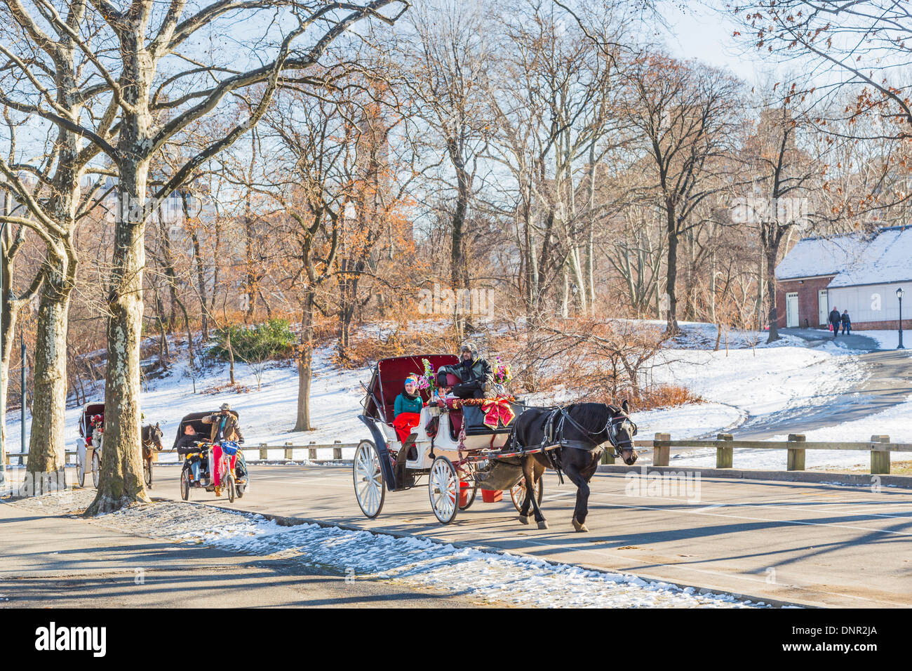 Horse drawn carriages and snow in new york city hi-res stock ...