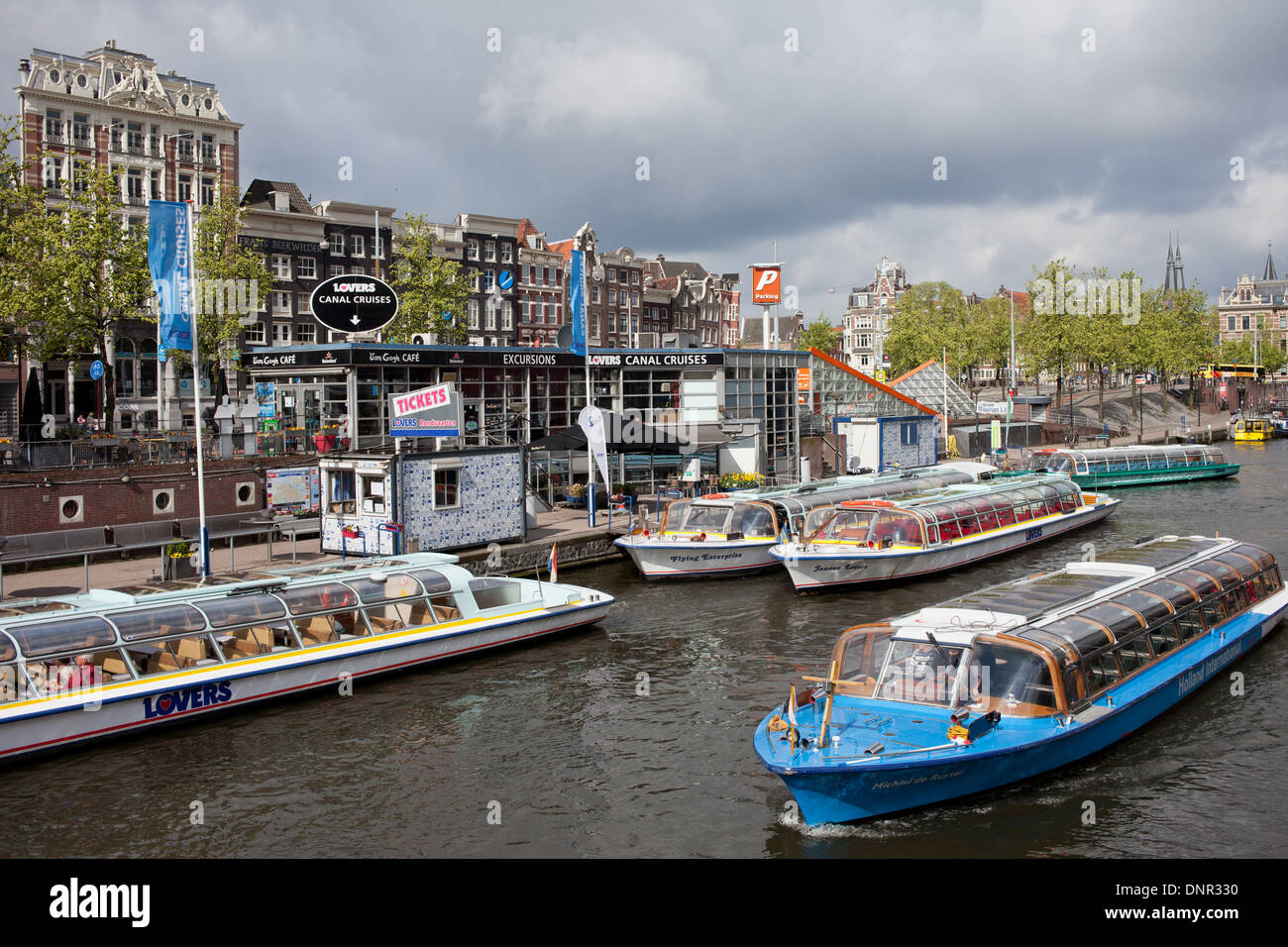 Passenger boats ready for canal cruises in Amsterdam, Holland ...