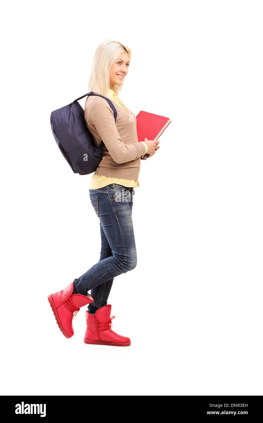 Full length portrait of female student in red boots holding books Stock ...
