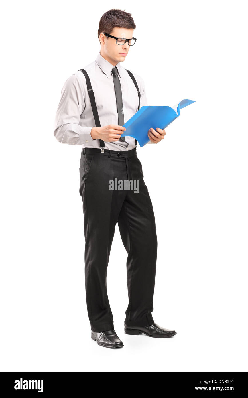 Full length portrait of young man reading papers Stock Photo - Alamy