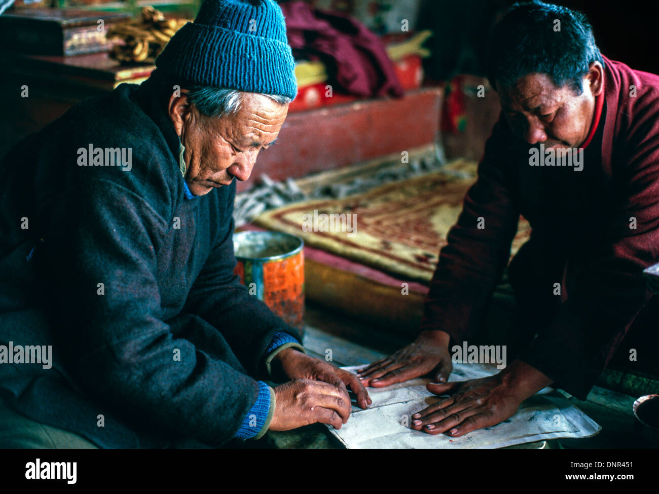 A local artist & the head monk work together on a paper template for ...