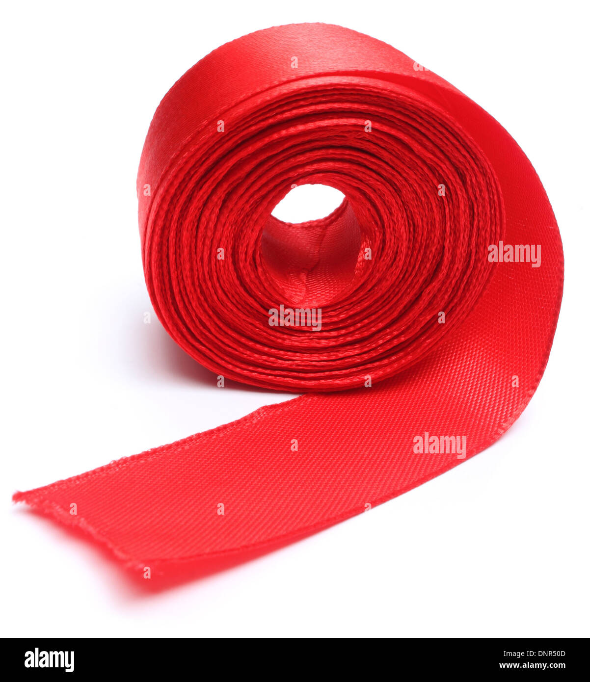 Closeup of red ribbon roll over white background Stock Photo - Alamy