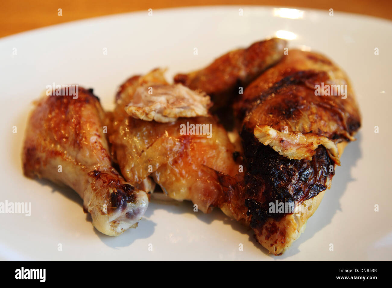 Rotisserie cooked chicken served on a white plate Stock Photo - Alamy